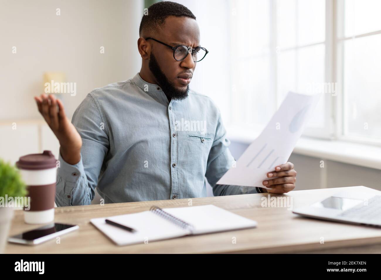 Shocked Black Businessman Looking Through Papers Working Sitting In ...