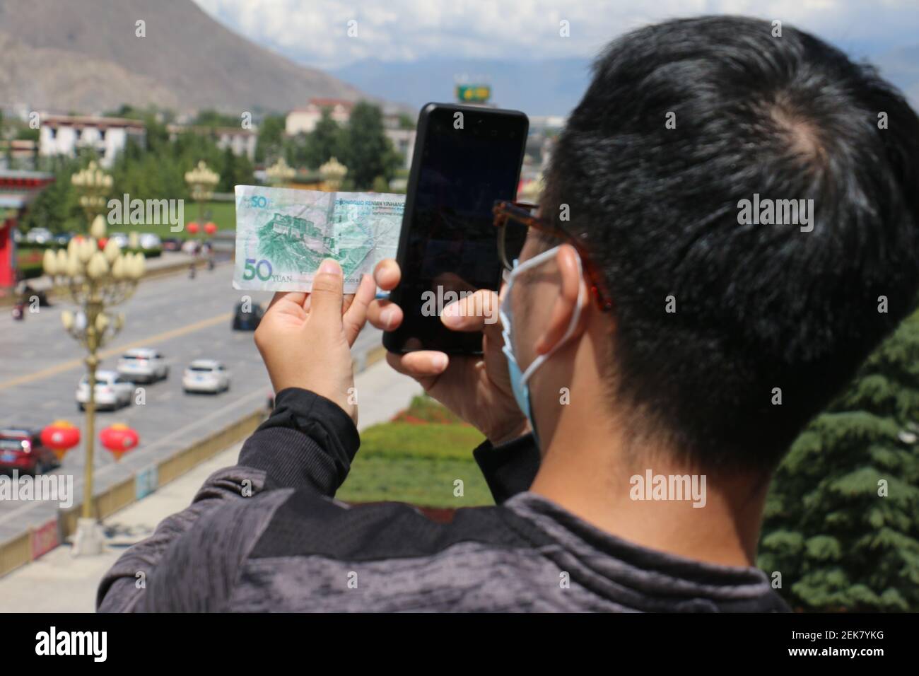 LHASA, CHINA - JULY 2, 2020 - Tourists take photos with RMB 50 on the ...