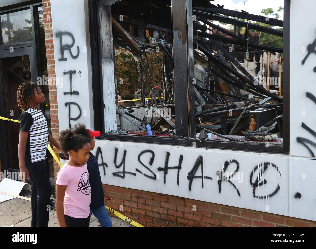 Children take in the burned out Atlanta Wendy's where Rayshard Brooks ...