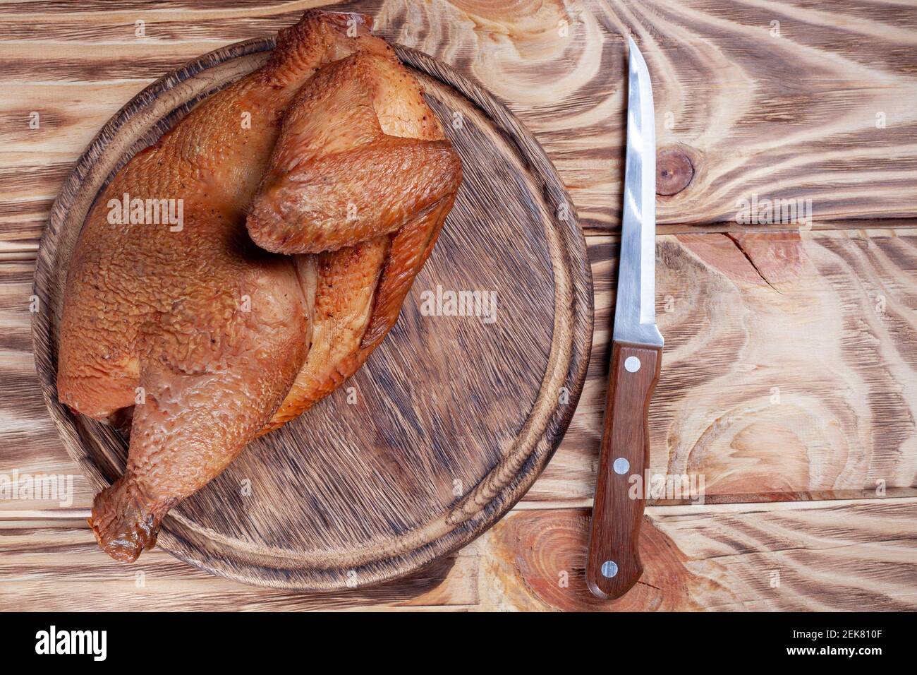 grilled half chicken on wooden board with sharp knife. fried chicken on ...