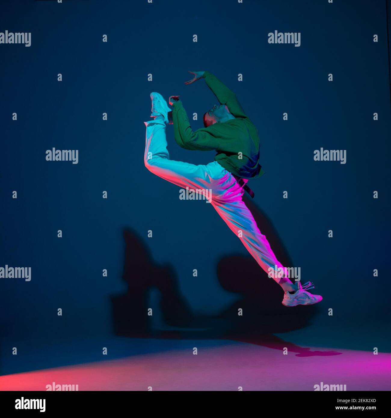 Flying. Stylish sportive boy dancing hip-hop in stylish clothes on ...