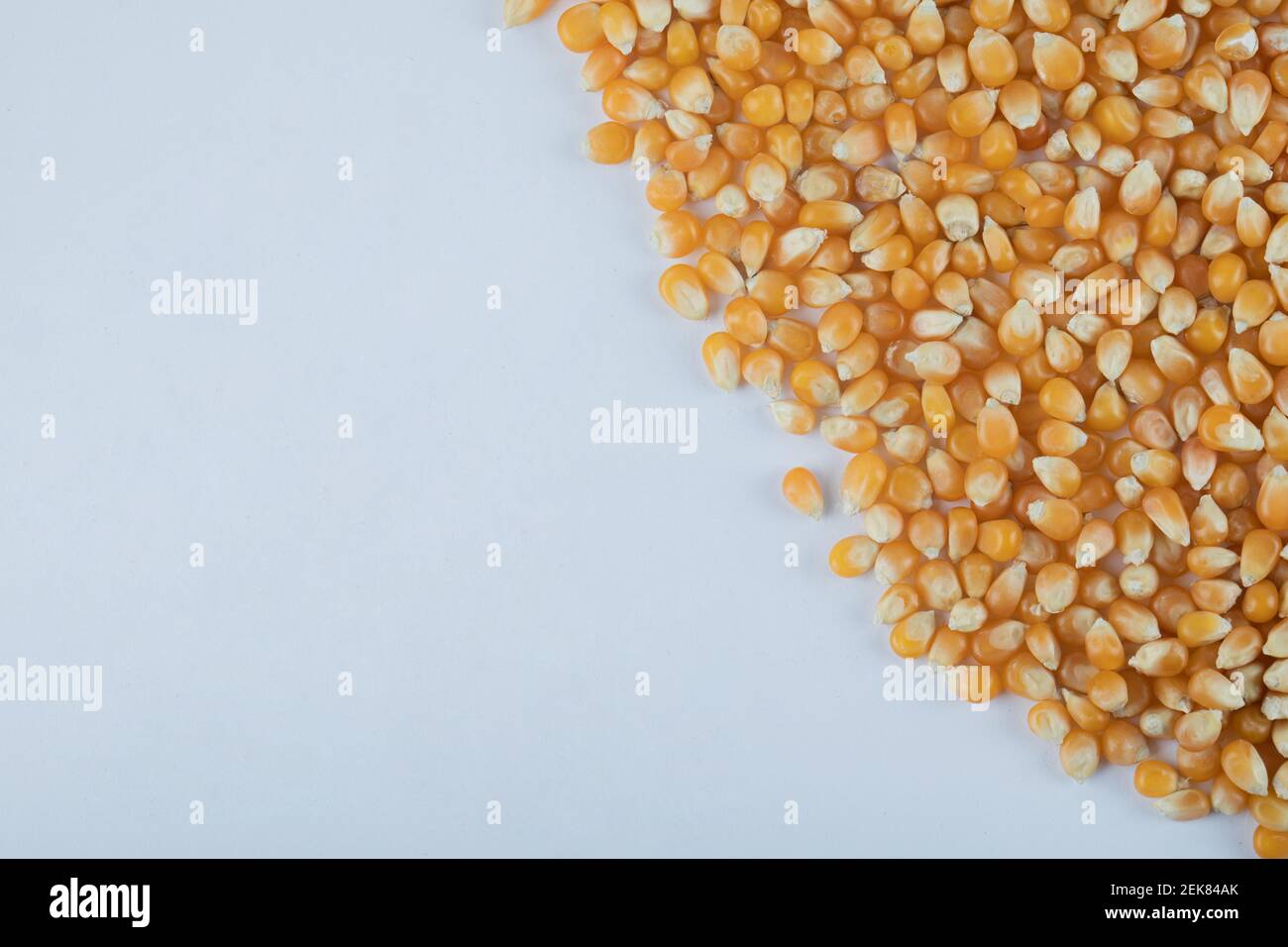 Heap of raw popcorn grains texture background Stock Photo - Alamy