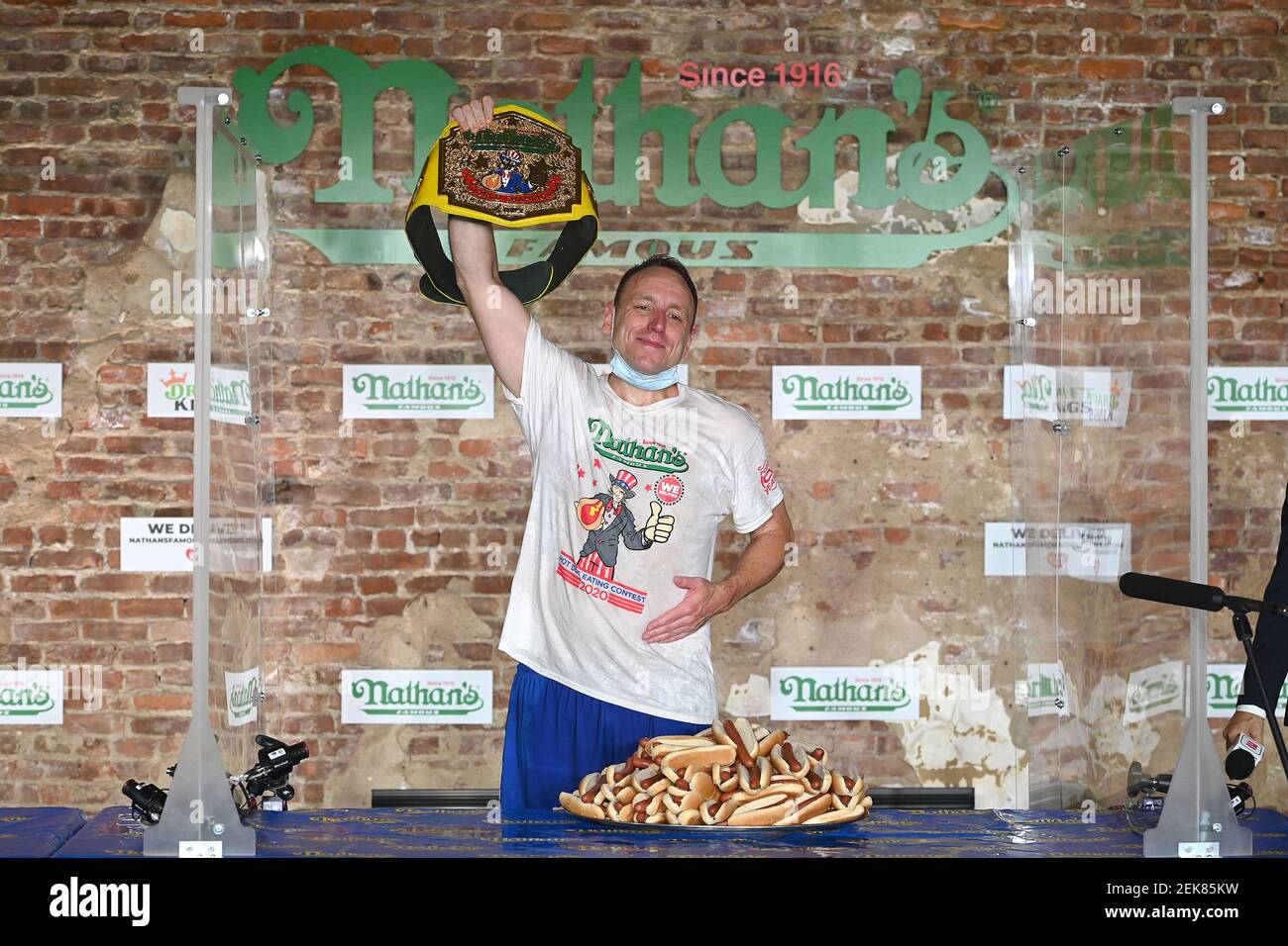 Competitive eater Joey Chestnut celebrates after setting a new world ...