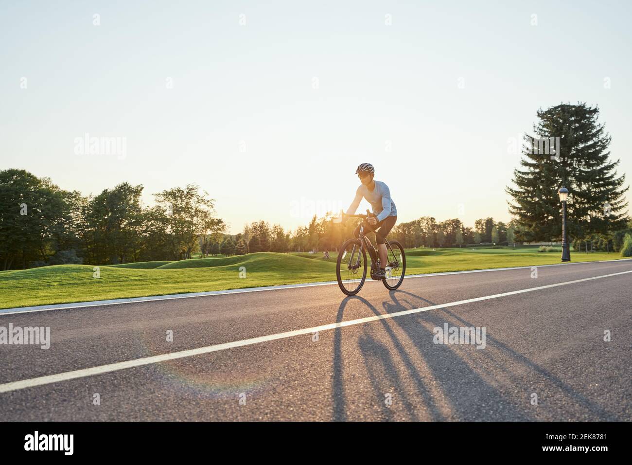 Full length shot of professional male racer in sportswear and helmet ...