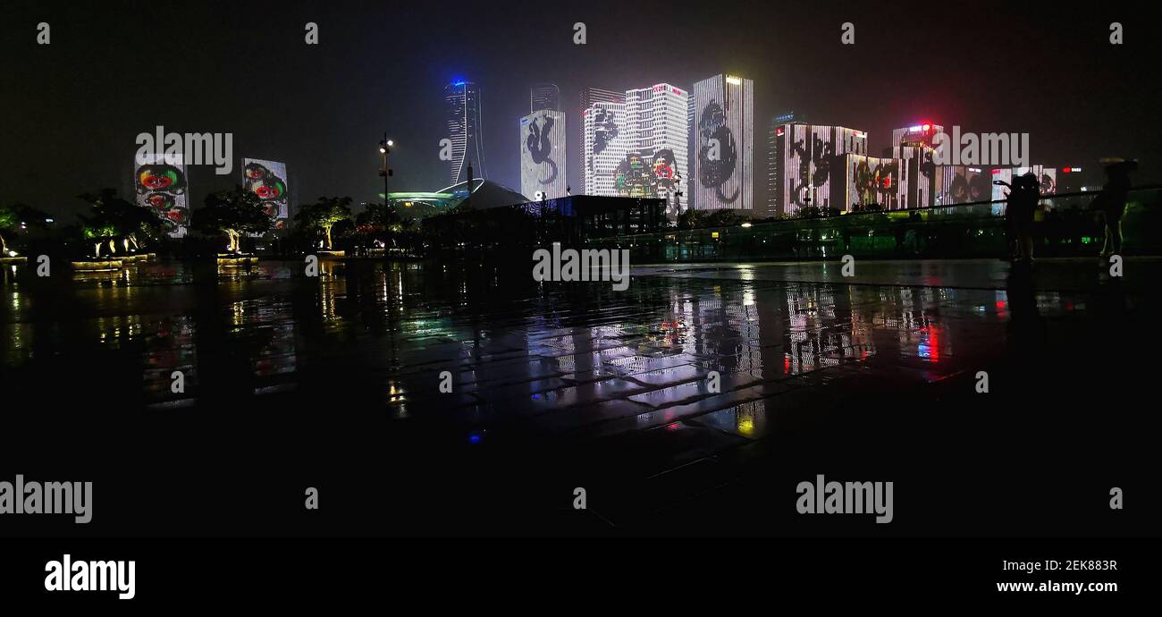 Buildings with LED lights on and their reflections on the Qiantang ...