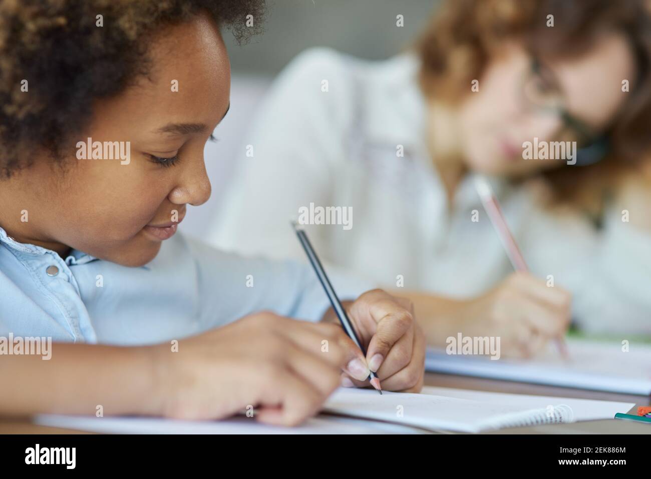 Dedication. Close up shot of mixed race teen girl looking concentrated ...
