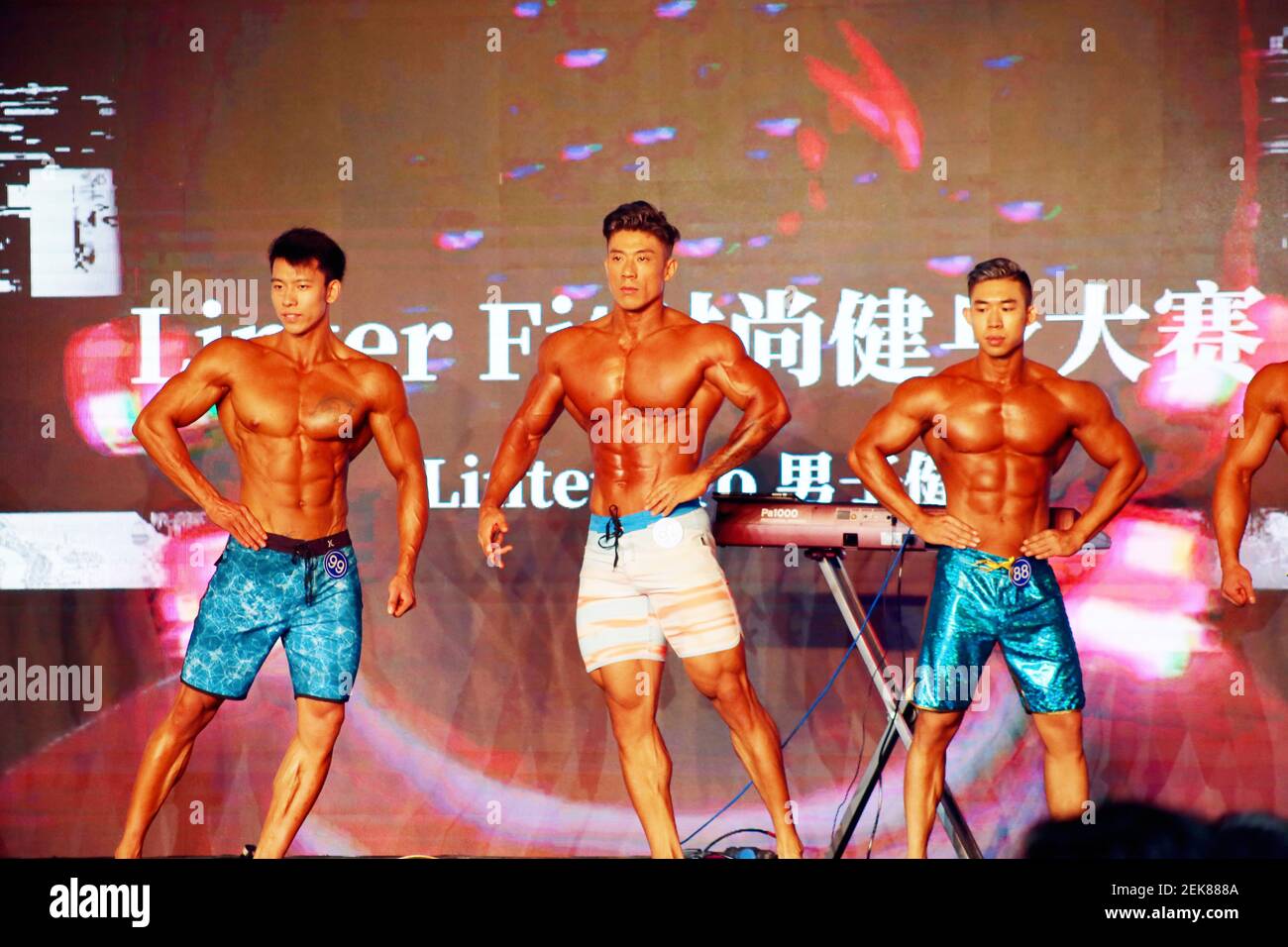 Male participants pose to show their muscle and body during a ...