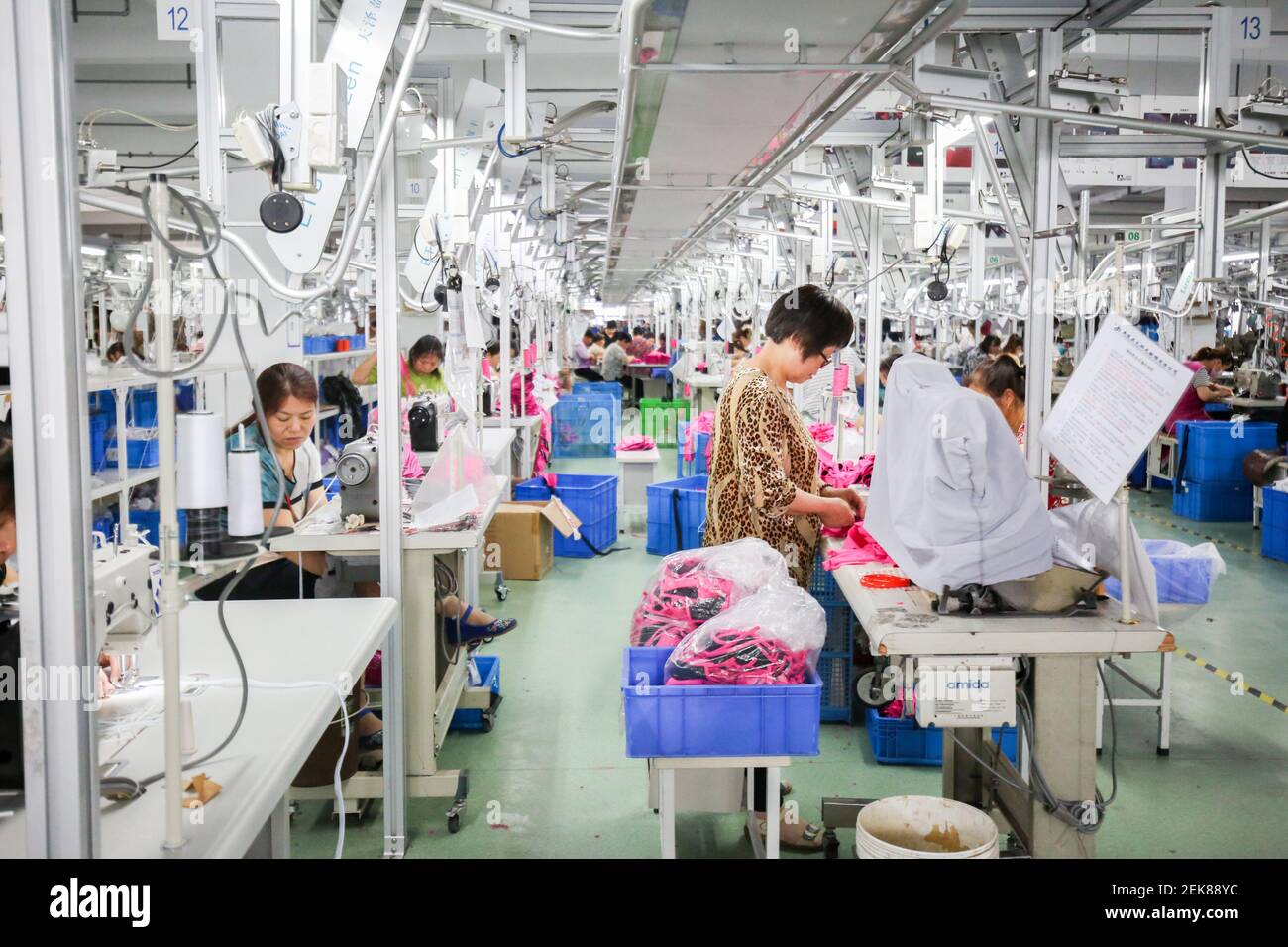 Workers are busy at producing hats at a workshop of local factory to ...