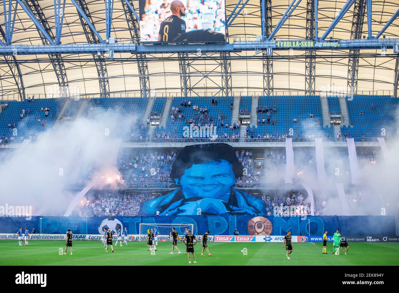 Supporters of Lech Poznan display a banner with images of Pablo Escobar ...