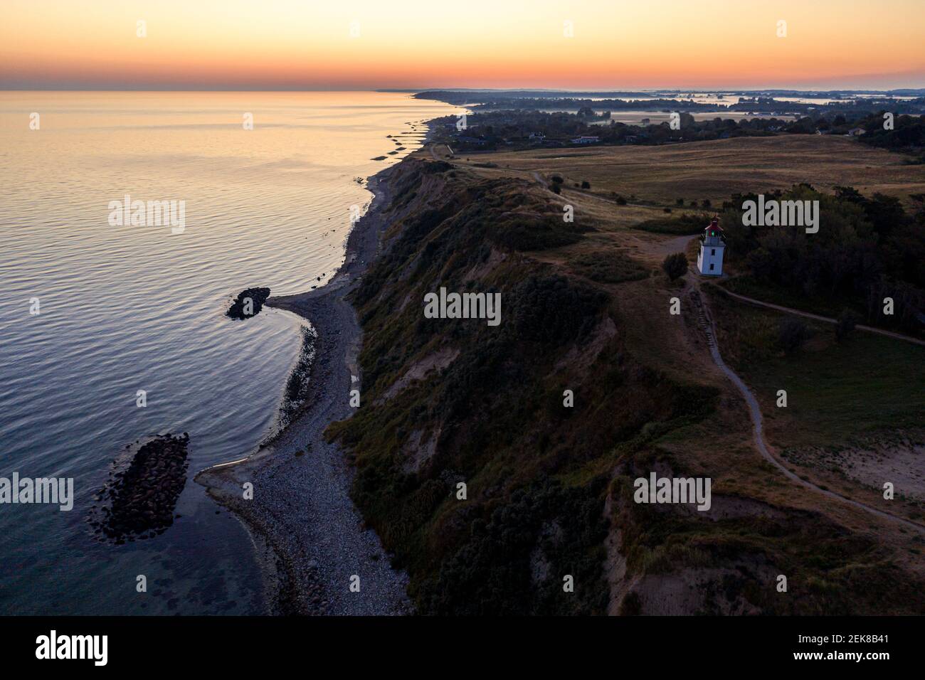 Spodsbjerg Lighthouse and Coastline during Sunrise Stock Photo - Alamy