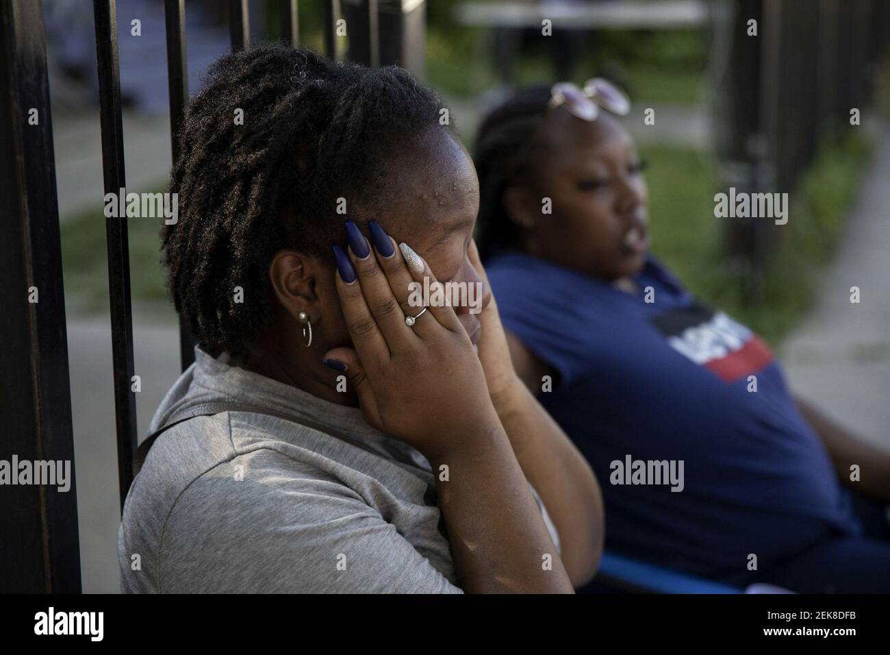 Kamesha Maclin wipes tears from her eyes during a vigil for her 7-year ...