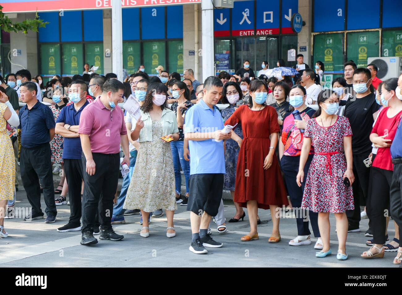 Parents wait for their children outside a testing center in the ...