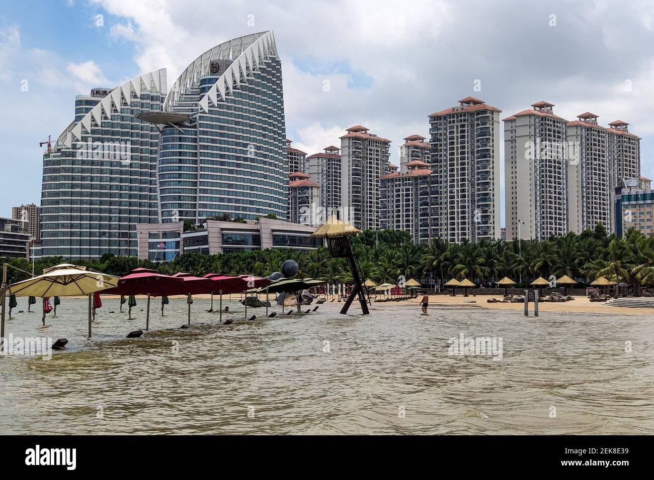 Some of the relaxation aera of a beach is swallowed by rising tide ...