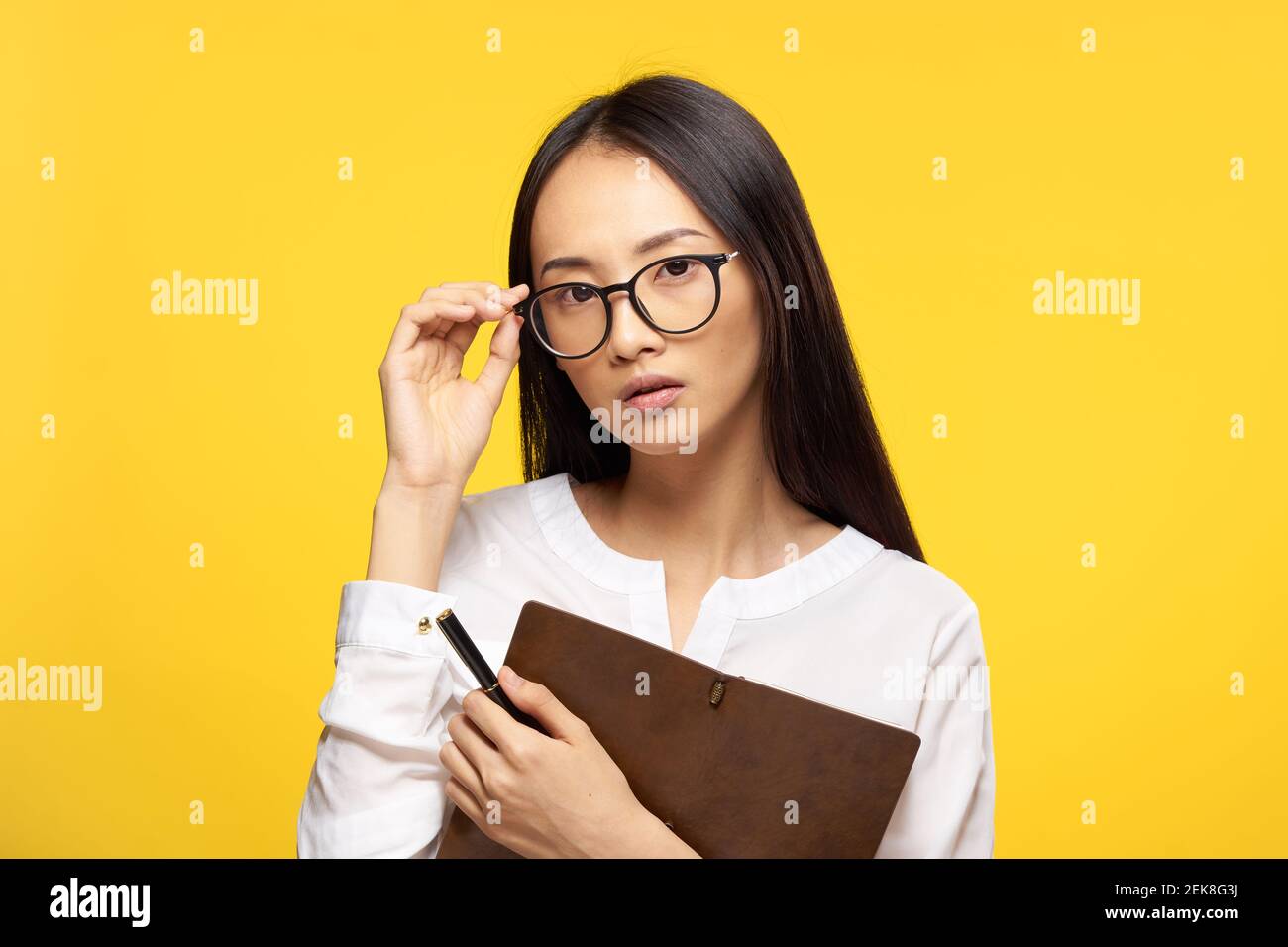 woman holding notepad secretary office yellow background Stock Photo ...