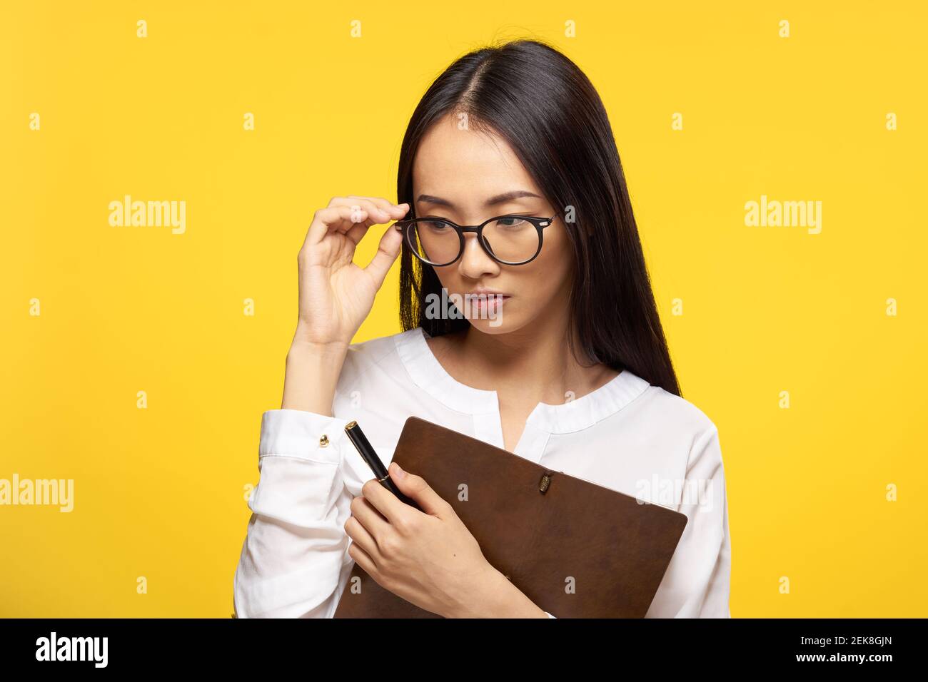 woman holding notepad secretary office yellow background Stock Photo ...