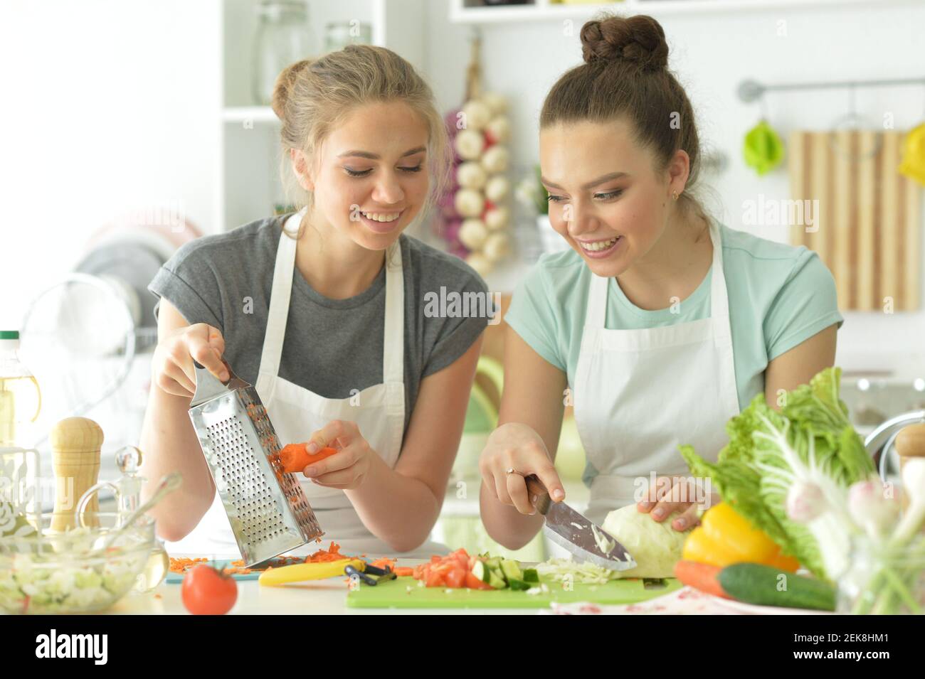 Portrait of beautiful teenagers cooking in kitchen Stock Photo - Alamy