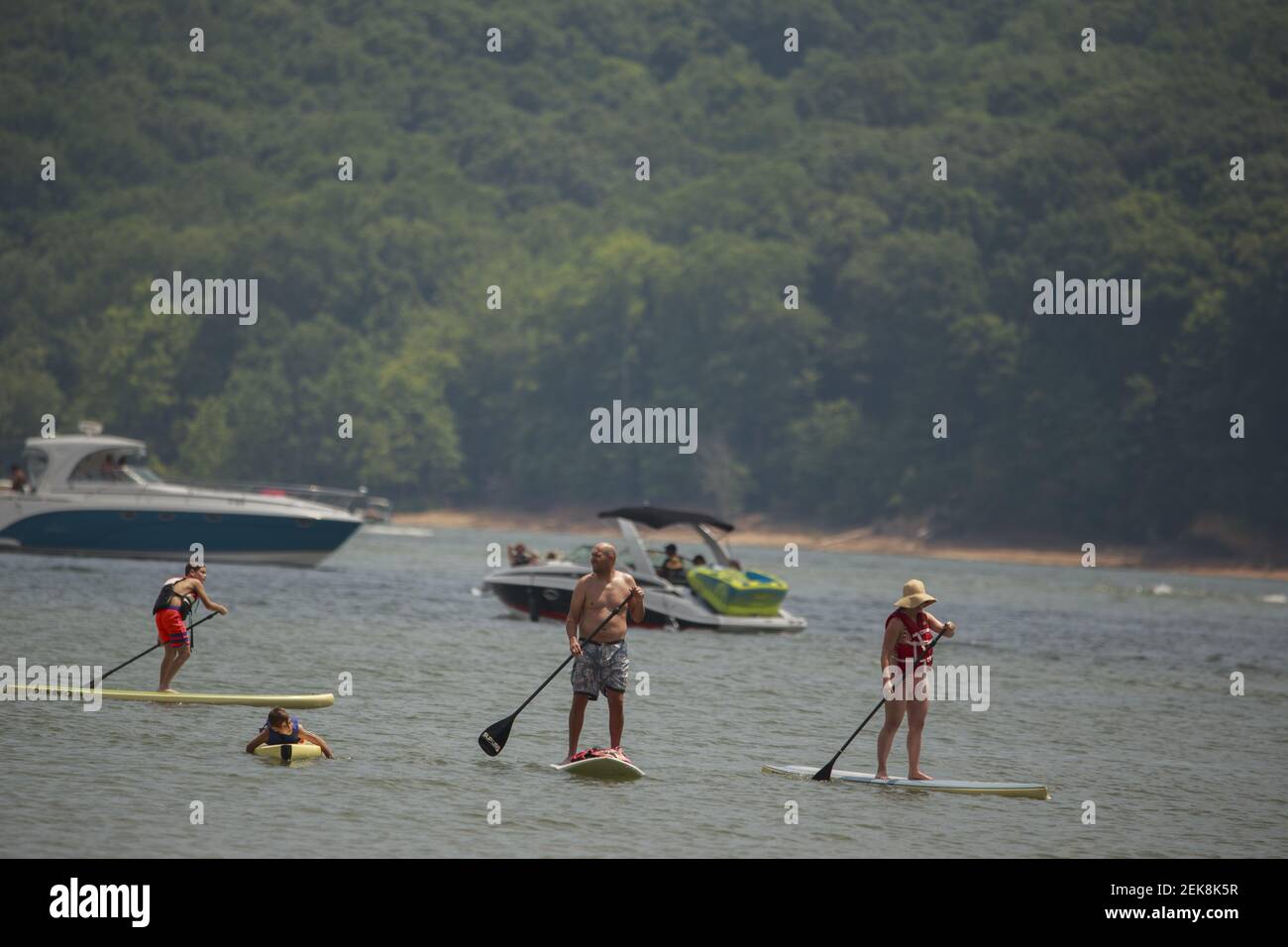 A group of paddle boarders float near boaters in Lake Monroe at Fairfax ...
