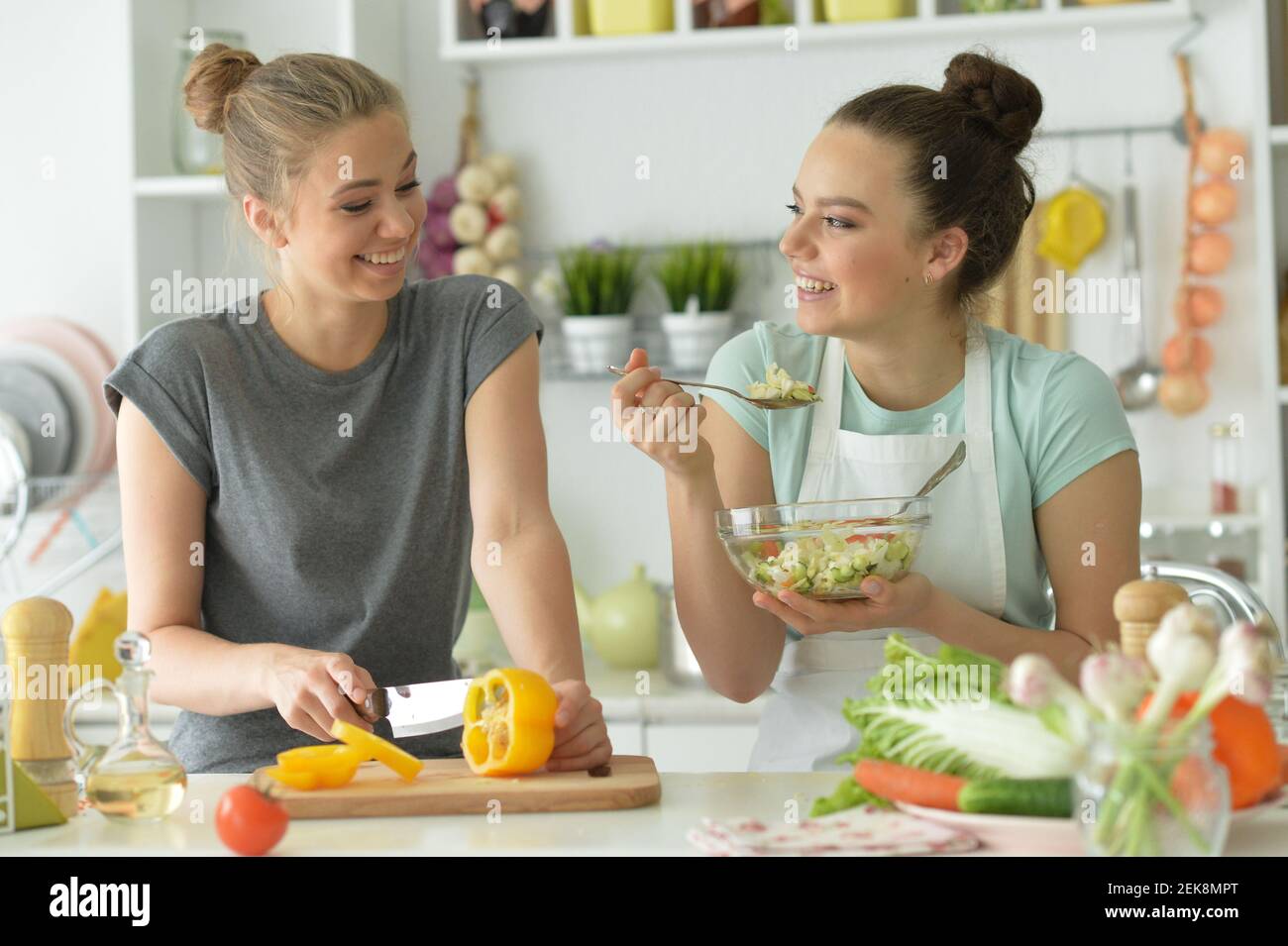 Portrait of beautiful teenagers cooking in kitchen Stock Photo - Alamy
