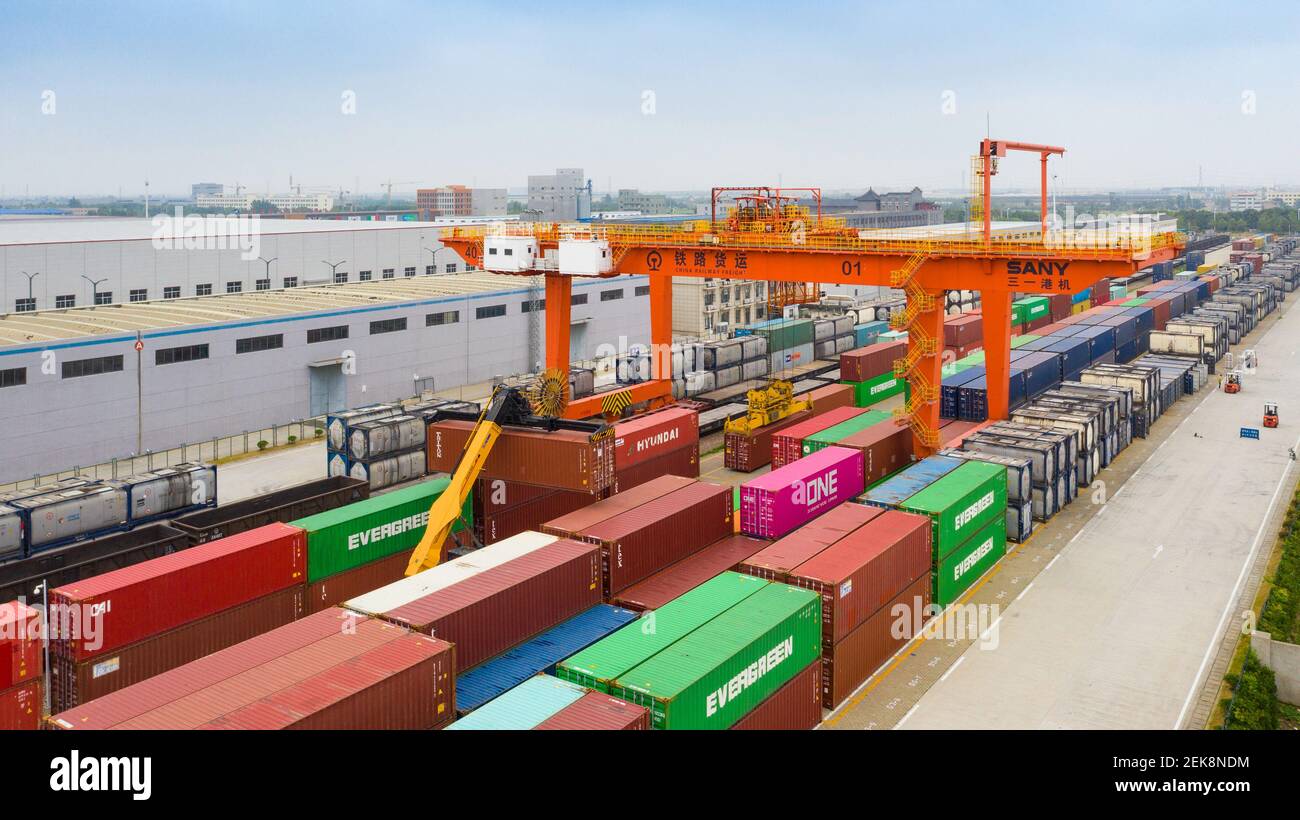 Aerial view of gantry cranes uploading containers at a port of Shanghai ...