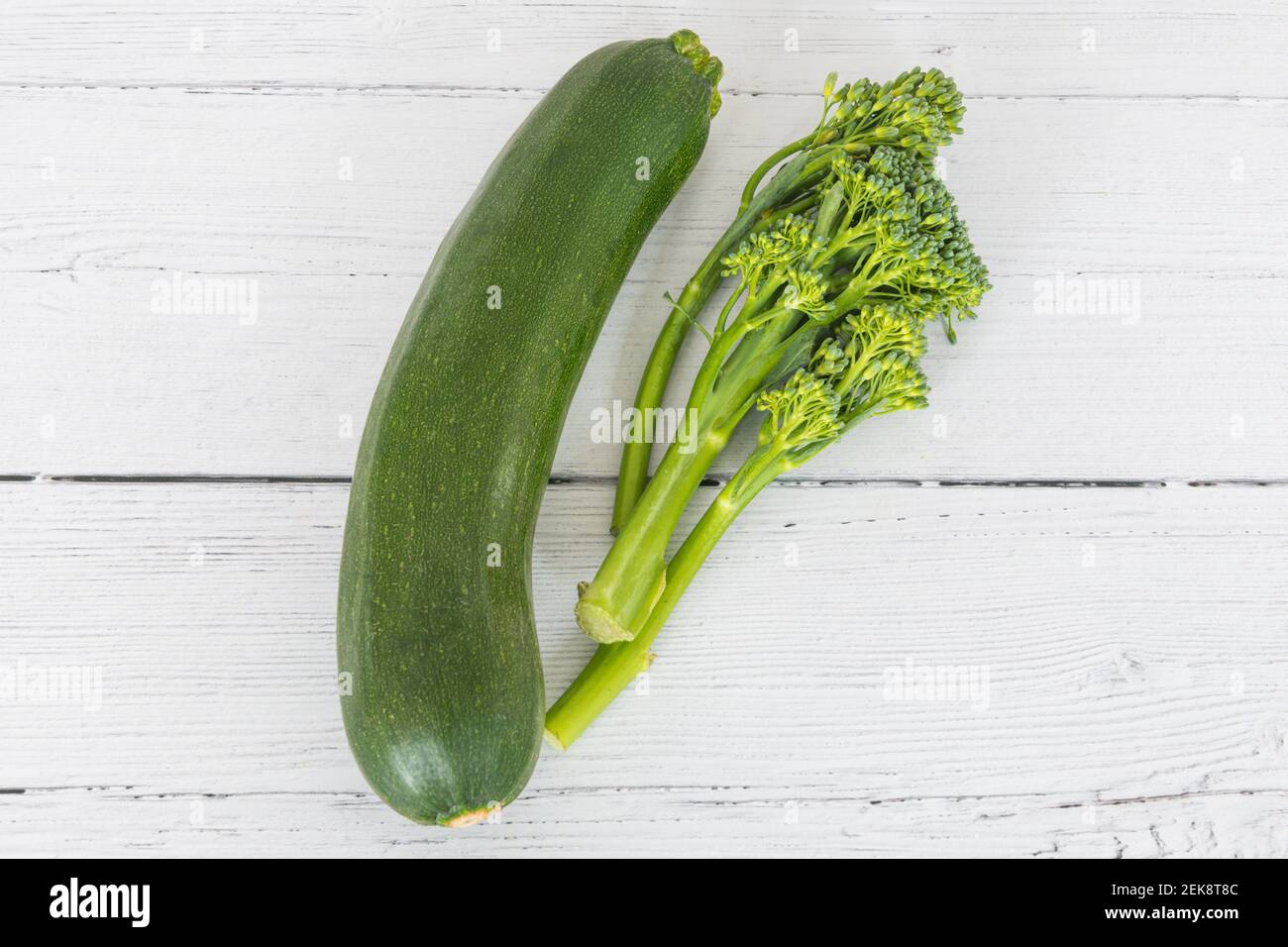 Tenderstem Broccoli and a Single Courgette lying on a white board Stock ...