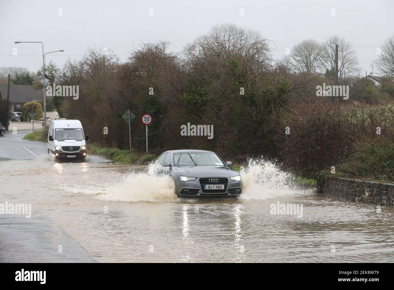 Vehicles are driven through flood water in Mallow, County Cork, in the ...