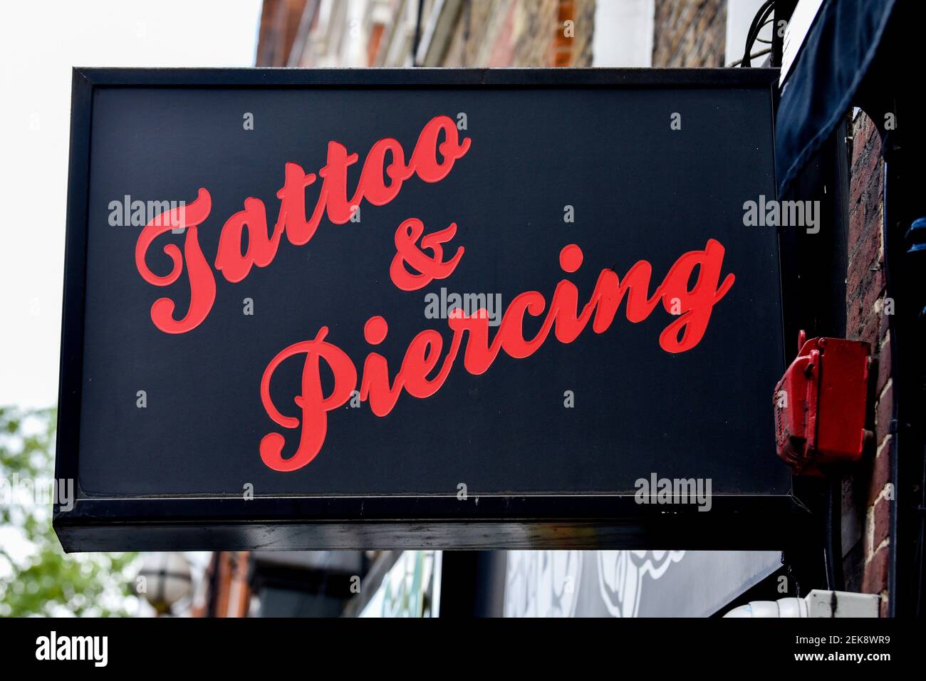 A Tattoo and Piercing studio sign in Camden, London. (Photo by Dave ...