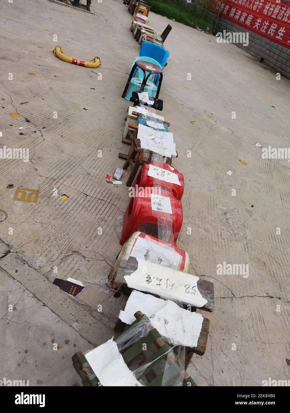 People put name tags on the chairs parents brought with them as line-up ...