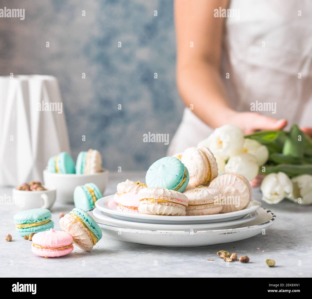 Colorful French or Italian macarons stack on red plate. Dessert for ...