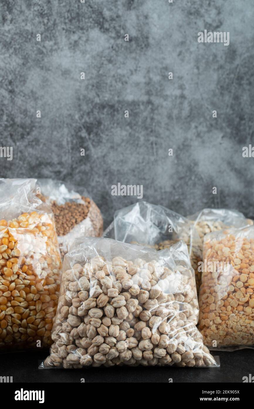 Different kinds of beans packed on a gray background Stock Photo - Alamy