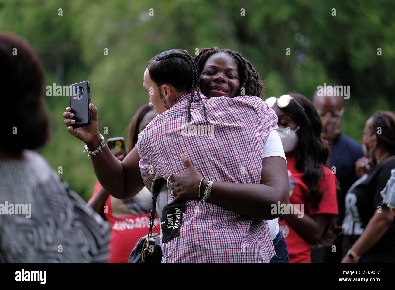 Dominique Dunn's mother receives a hug as family and friends gather in ...