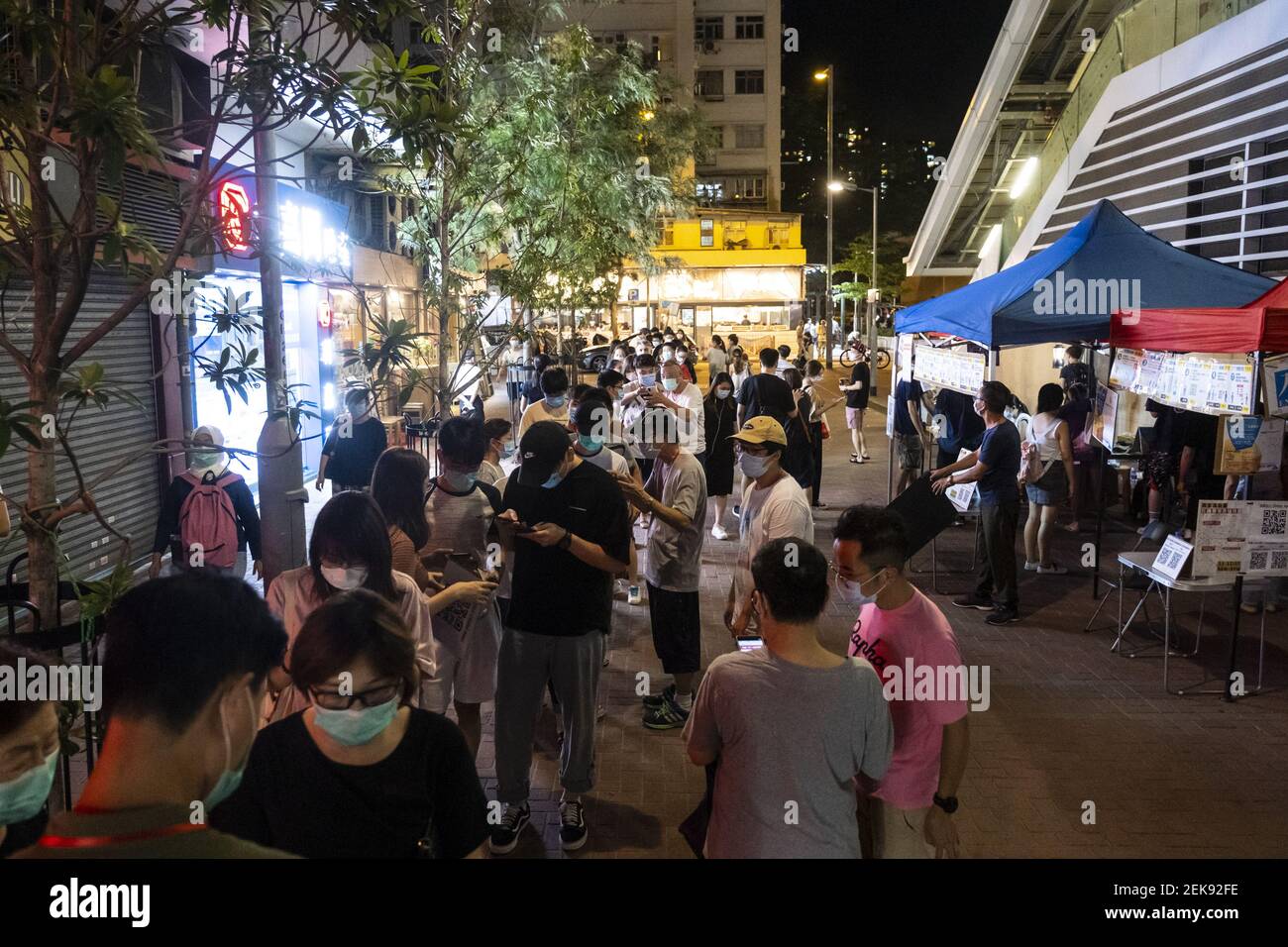 People queue up at a temporary polling station to vote for pro ...