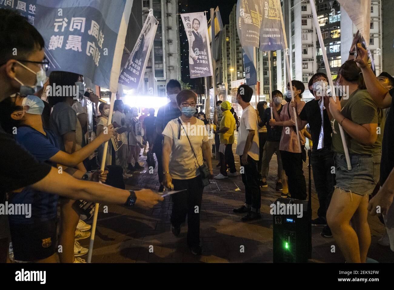 Volunteers distribute pamphlets to people outside a temporary polling ...