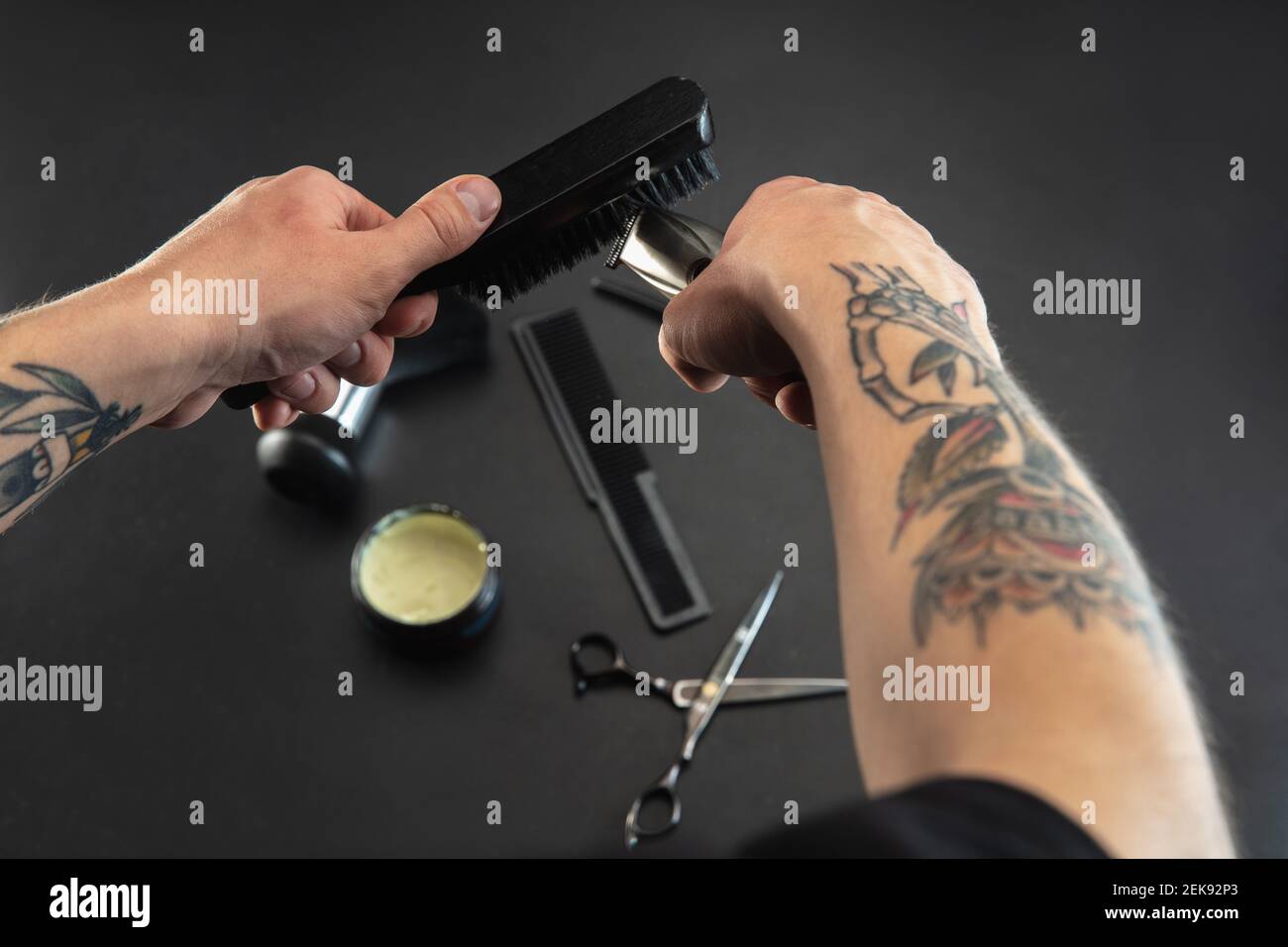 Hand of barber with equipment set on black table background. Close up ...
