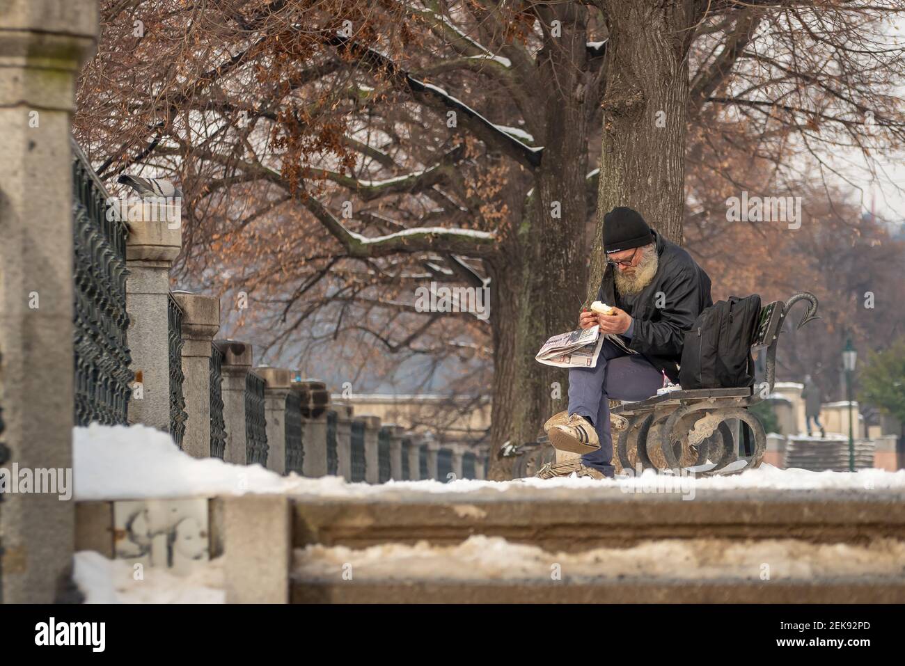 Prague, Czech Republic. 02-23-2021. Old homeless man is eating and ...