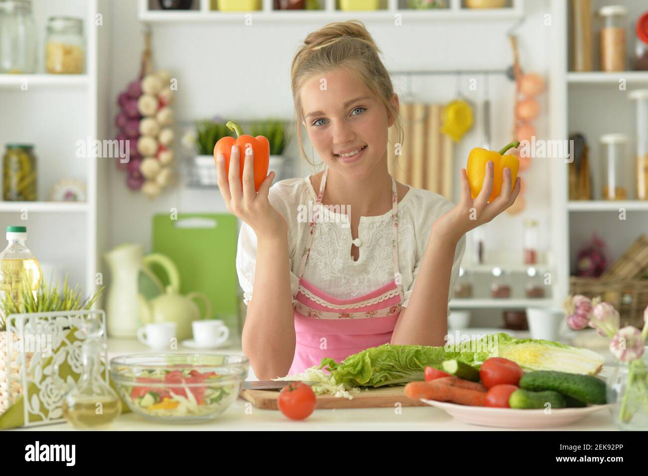 Portrait of beautiful teenager girl coocking on kitchen Stock Photo - Alamy