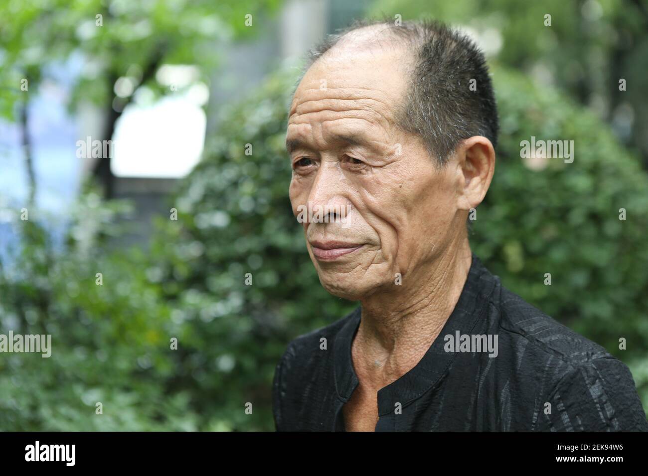 Mr. Jiang, a man in his seventies, practices Yoga in a special way, standing upside down with ...