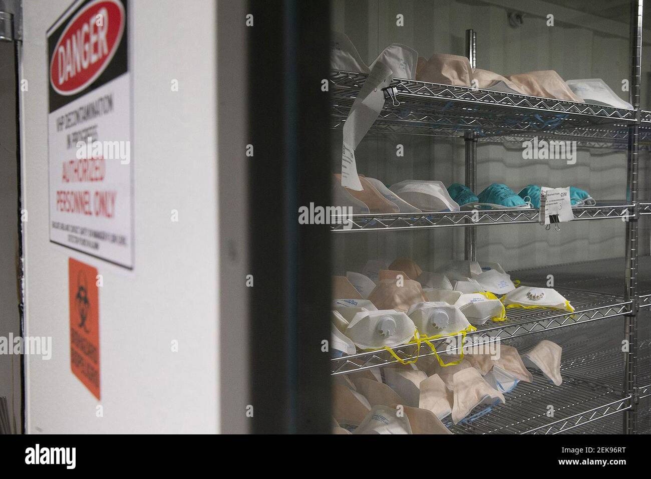 N95 hospital masks are stacked on shelves inside a shipping container ...