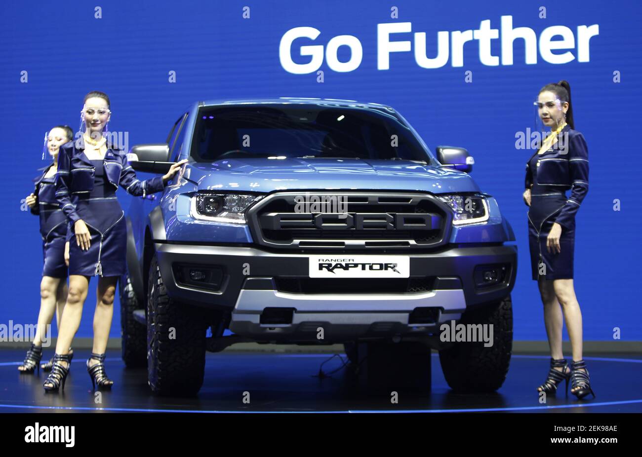 Models wearing face shields as a preventive measure pose next to a Ford ...