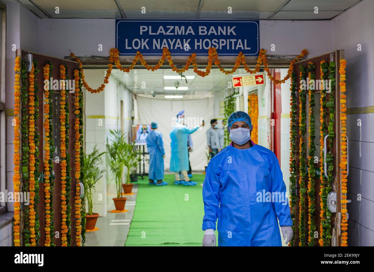A technician wearing a personal protective Equipment suit (PPE) is seen ...