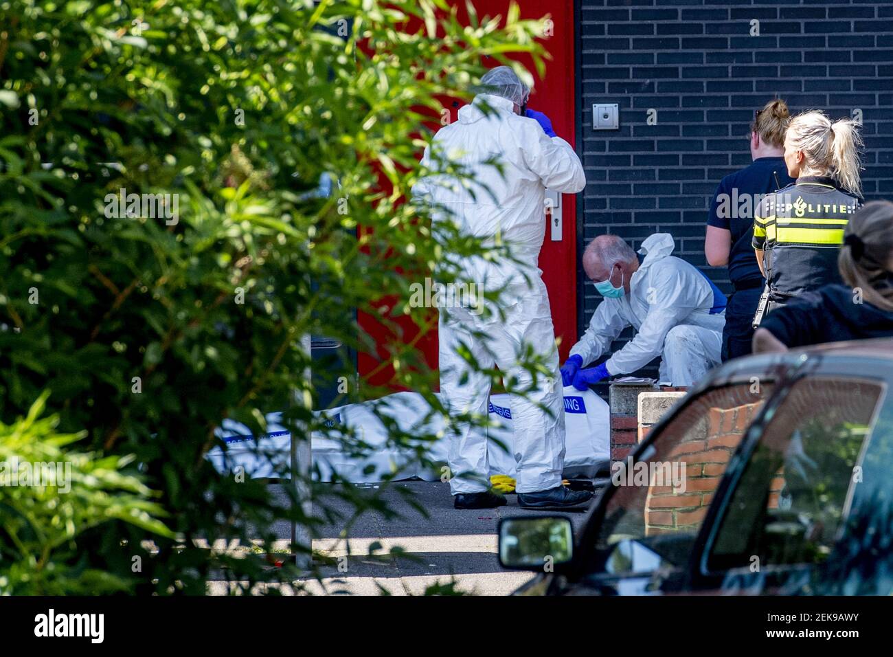 (EDITOR’S NOTE: Image depicts death) Forensic officers at the shooting ...