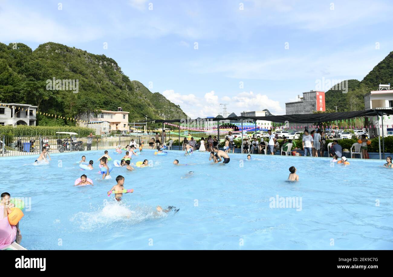 ANLONG, CHINA - JULY 15, 2020 - Residents swim in an outdoor pool to ...