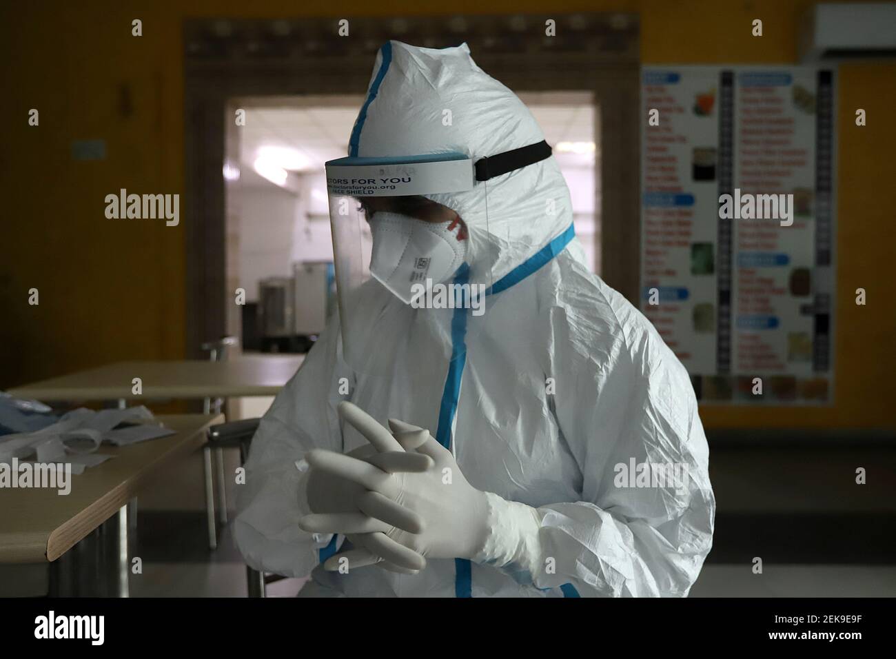 A doctor wears Personal Protective Equipment (PPE) as she prepares to ...