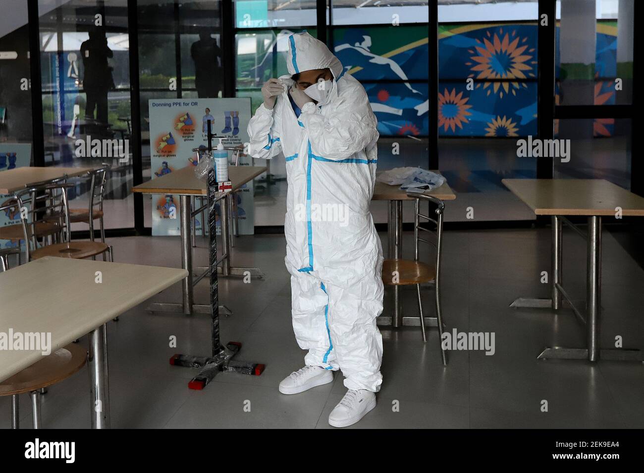 A doctor wears Personal Protective Equipment (PPE) as she prepares to ...