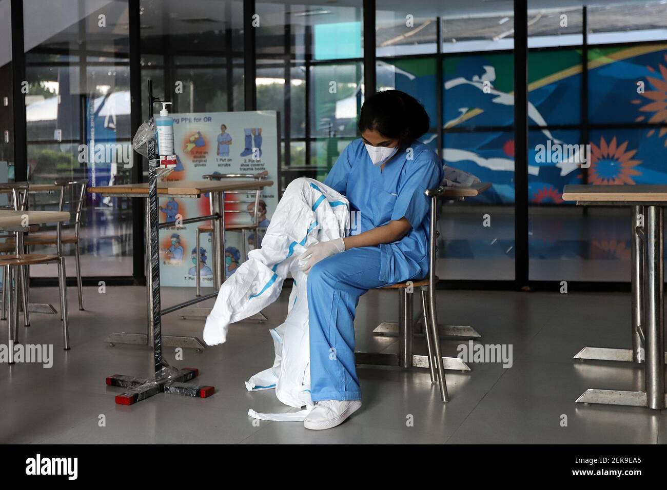 A doctor wears Personal Protective Equipment (PPE) as she prepares to ...