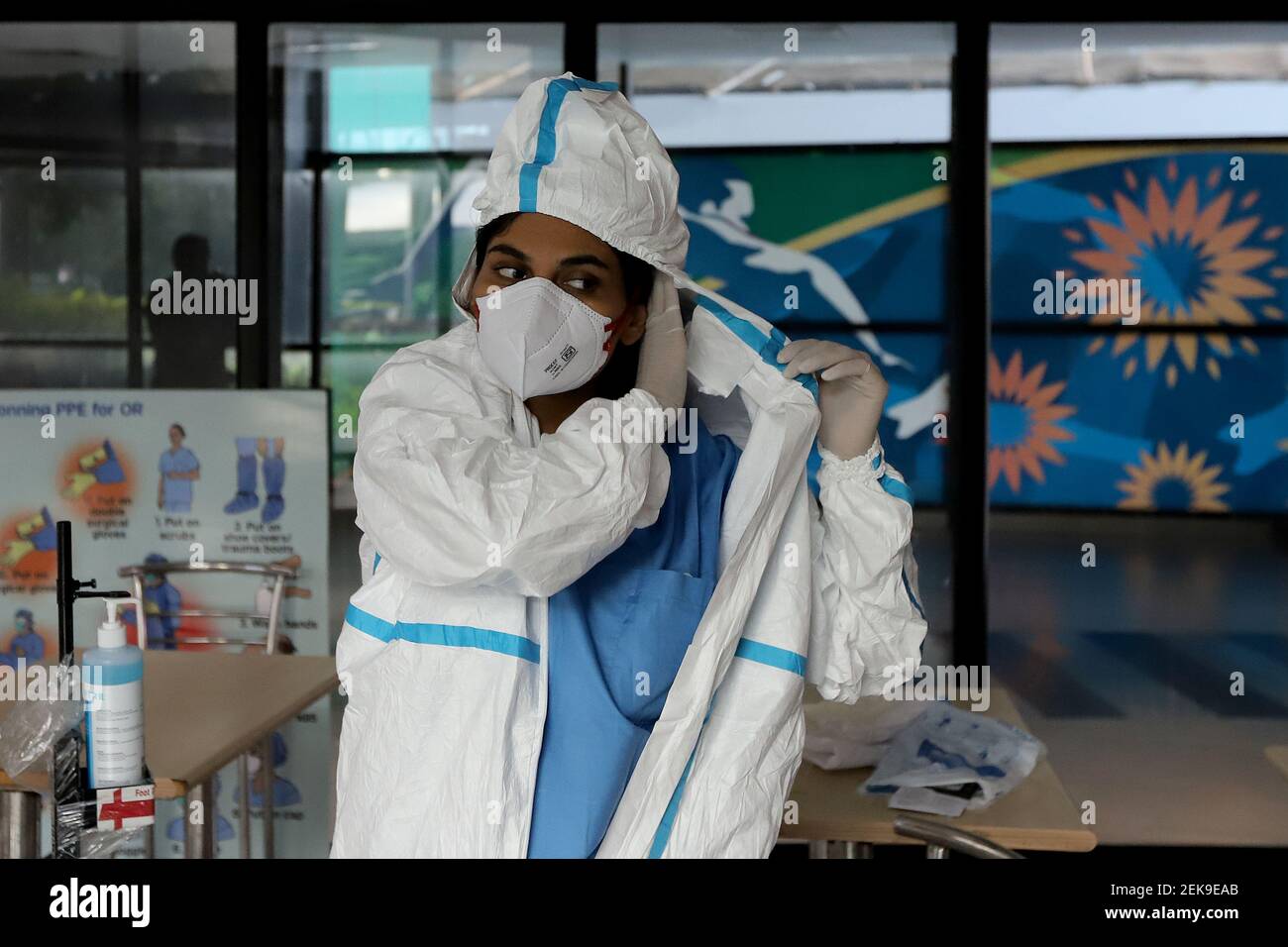 A doctor wears Personal Protective Equipment (PPE) as she prepares to ...