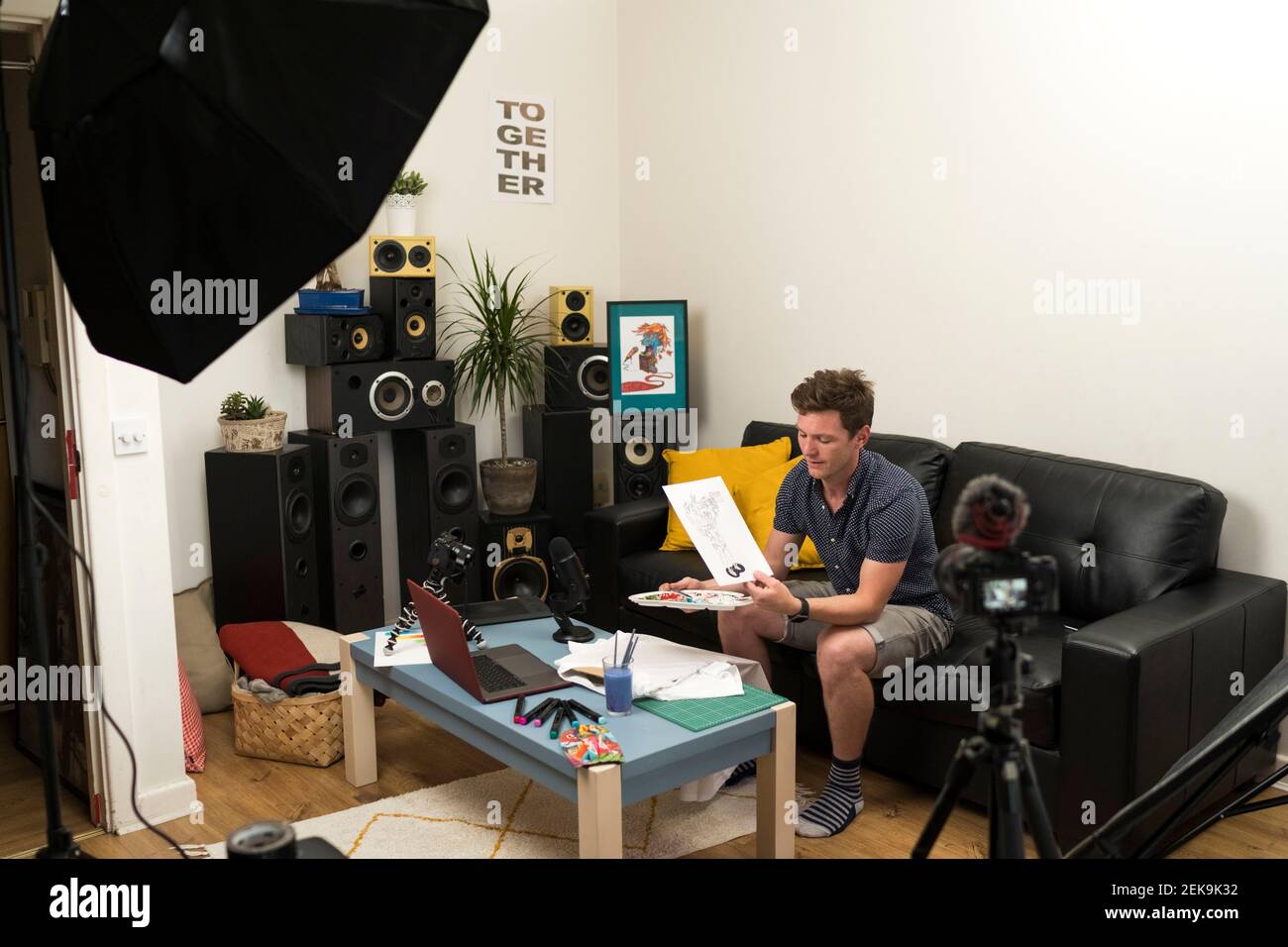 Content creator showing doodle while live streaming on camera at home ...