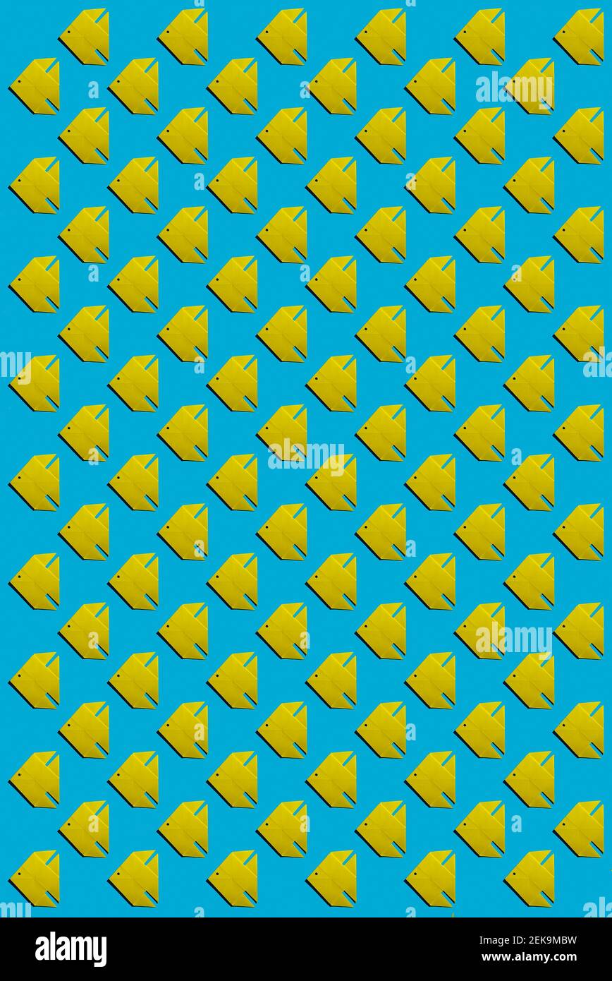Pattern of yellow origami fish against blue background Stock Photo - Alamy
