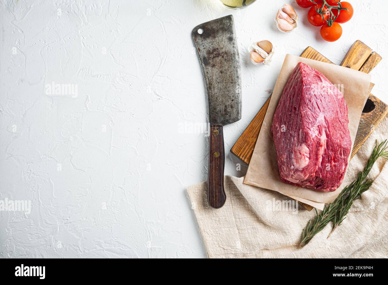Round beef meat raw set, on wooden cutting board with old butcher ...