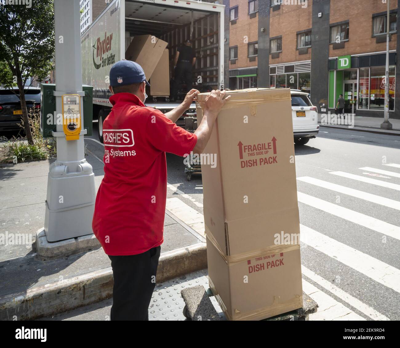 Moving van loading up in the Chelsea neighborhood in New York on Friday ...
