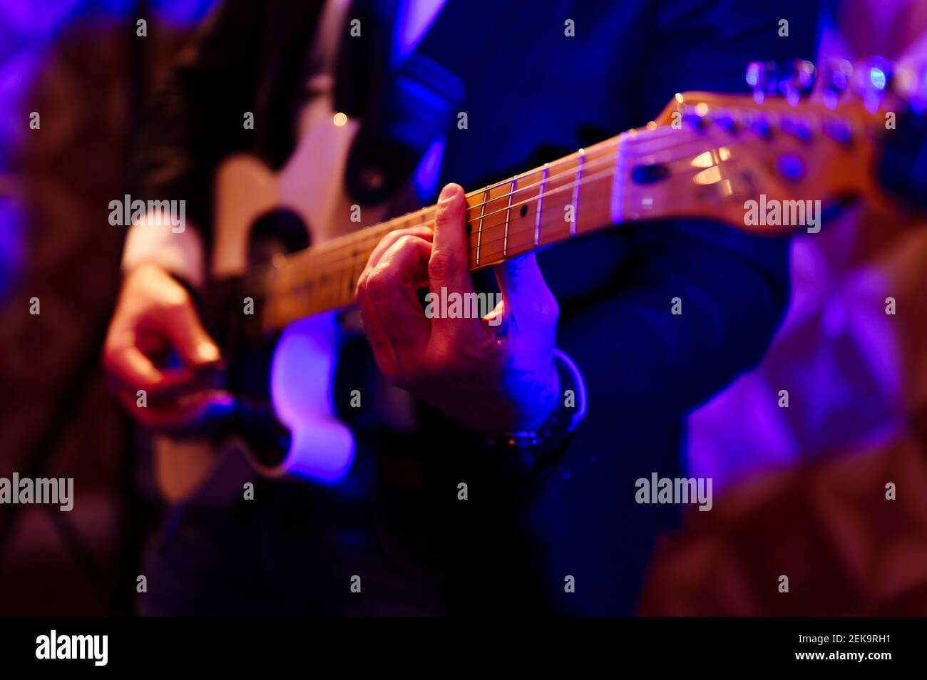 Male guitarist playing guitar at studio Stock Photo - Alamy